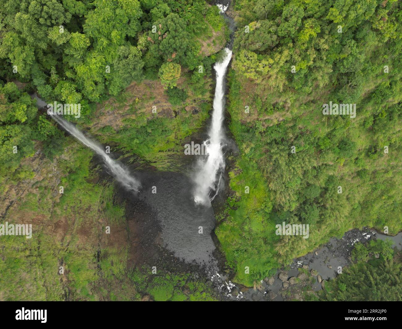 A picturesque scene of a cascading waterfall in Pakse, Laos Stock Photo ...