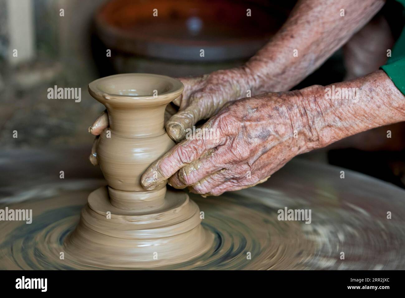 Old hands making pottery hi-res stock photography and images - Alamy