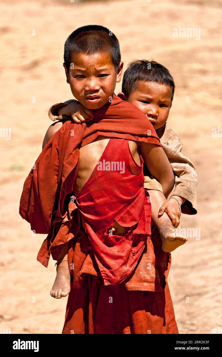 Boy carrying little boy, Myanmar, Burma, Burma, Southeast Asia Stock ...