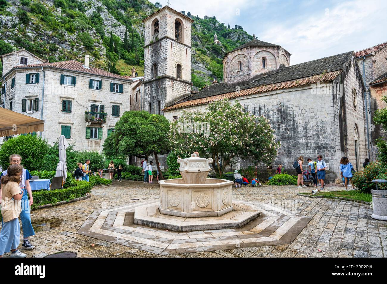 Drinking water fountain with the Church of St. Mary Collegiate in the ...