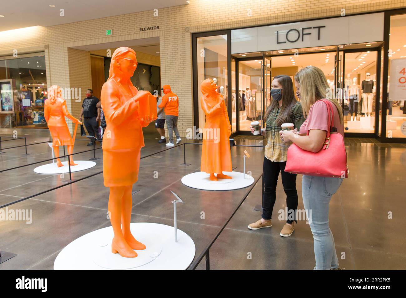 201015 -- DALLAS, Oct. 15, 2020 -- People look at a statue on display ...