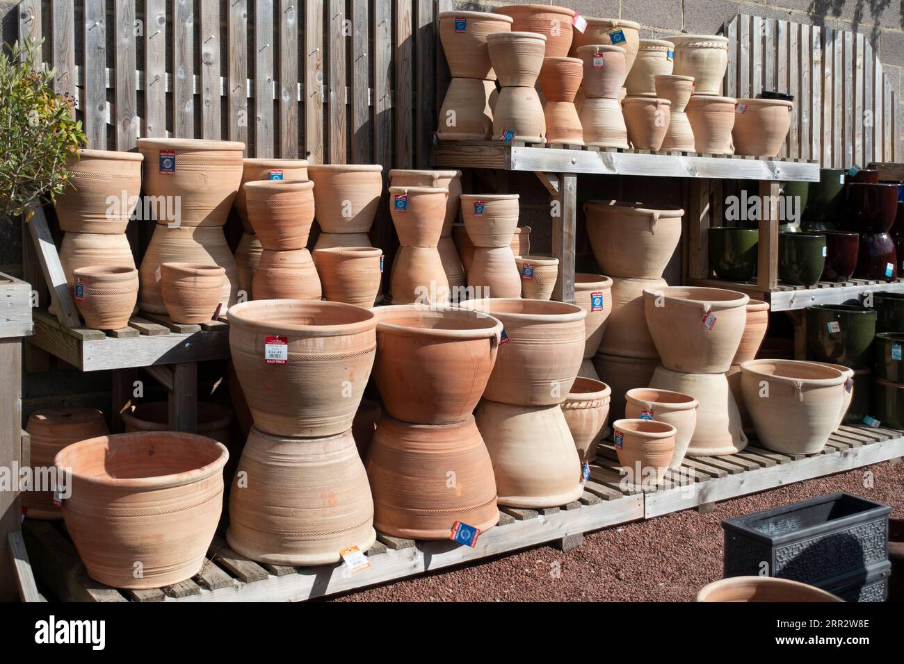 A display of brown terra cotta garden pots for sale in a garden centre ...