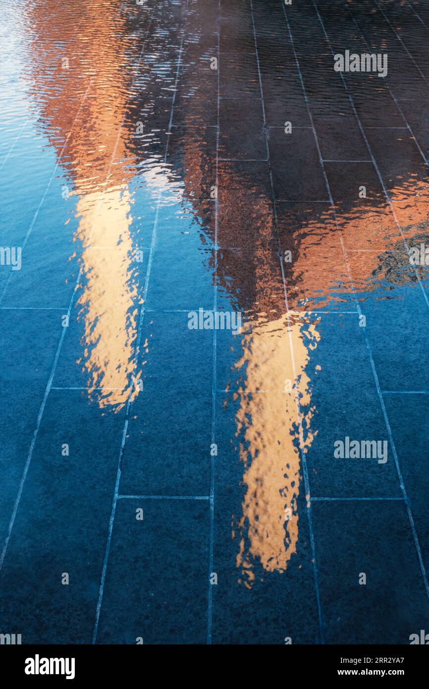 The iconic towers of Battersea Power Station in London reflected in a ...