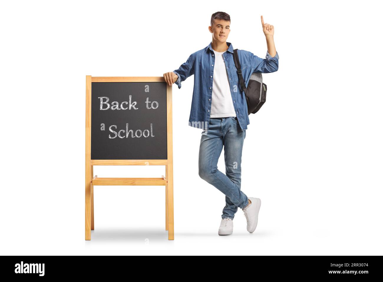 Full length portrait of a male teenage student with a backpack leaning ...