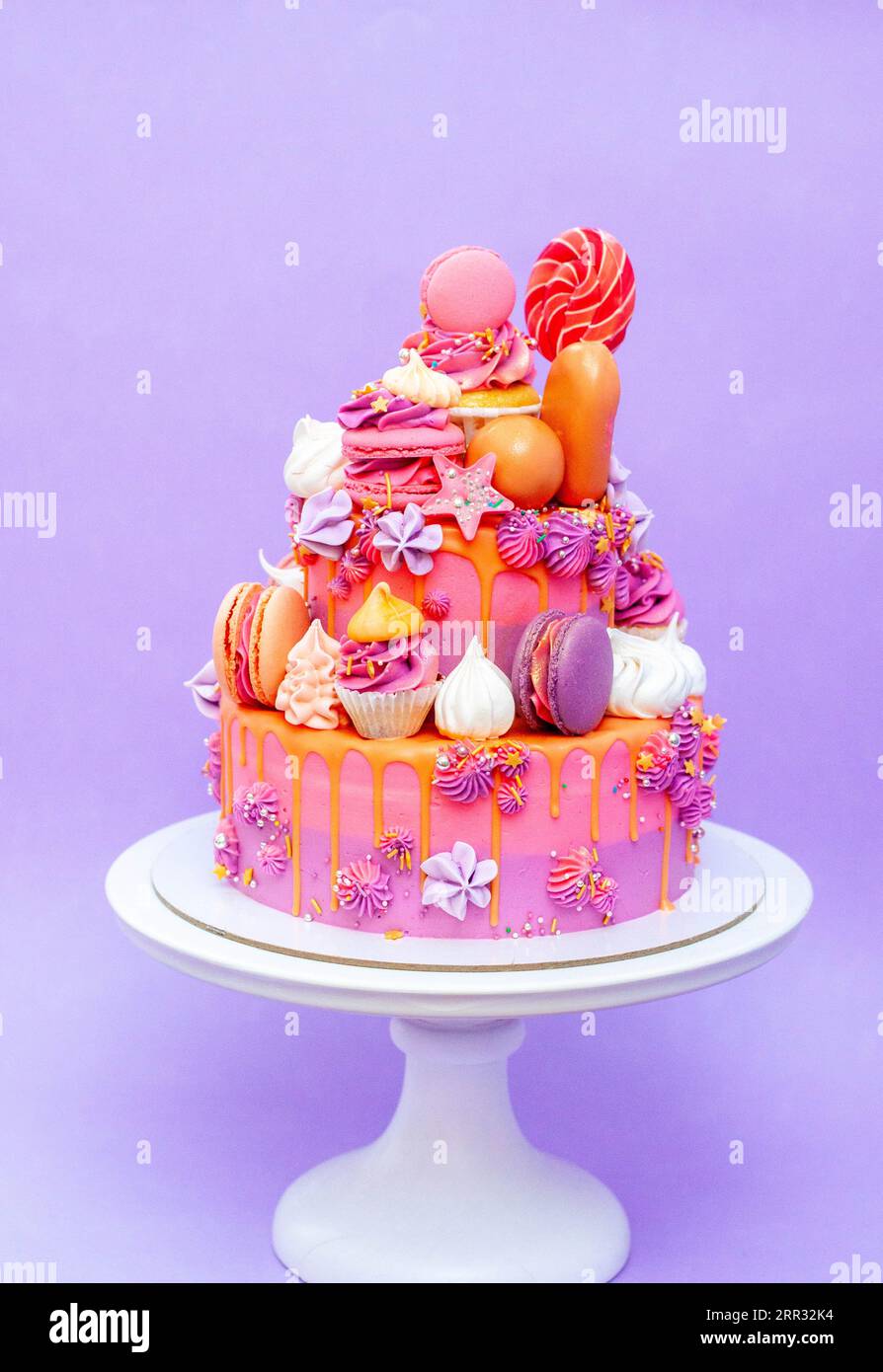 Pink, purple and orange gradient cake with cream cheese roses, macarons ...