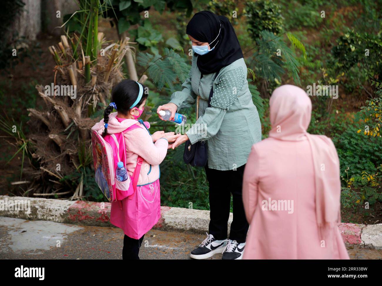 201021 -- ALGIERS, Oct. 21, 2020 -- An Algerian student sanitizes her ...