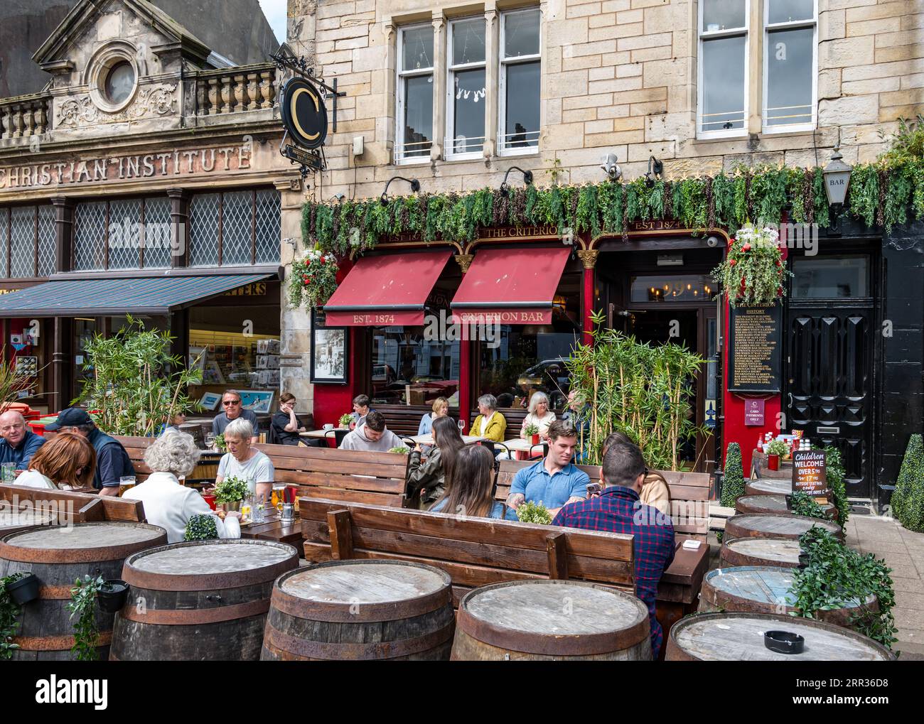 People eating and drinking at tables outside The Criterion Bar, St ...