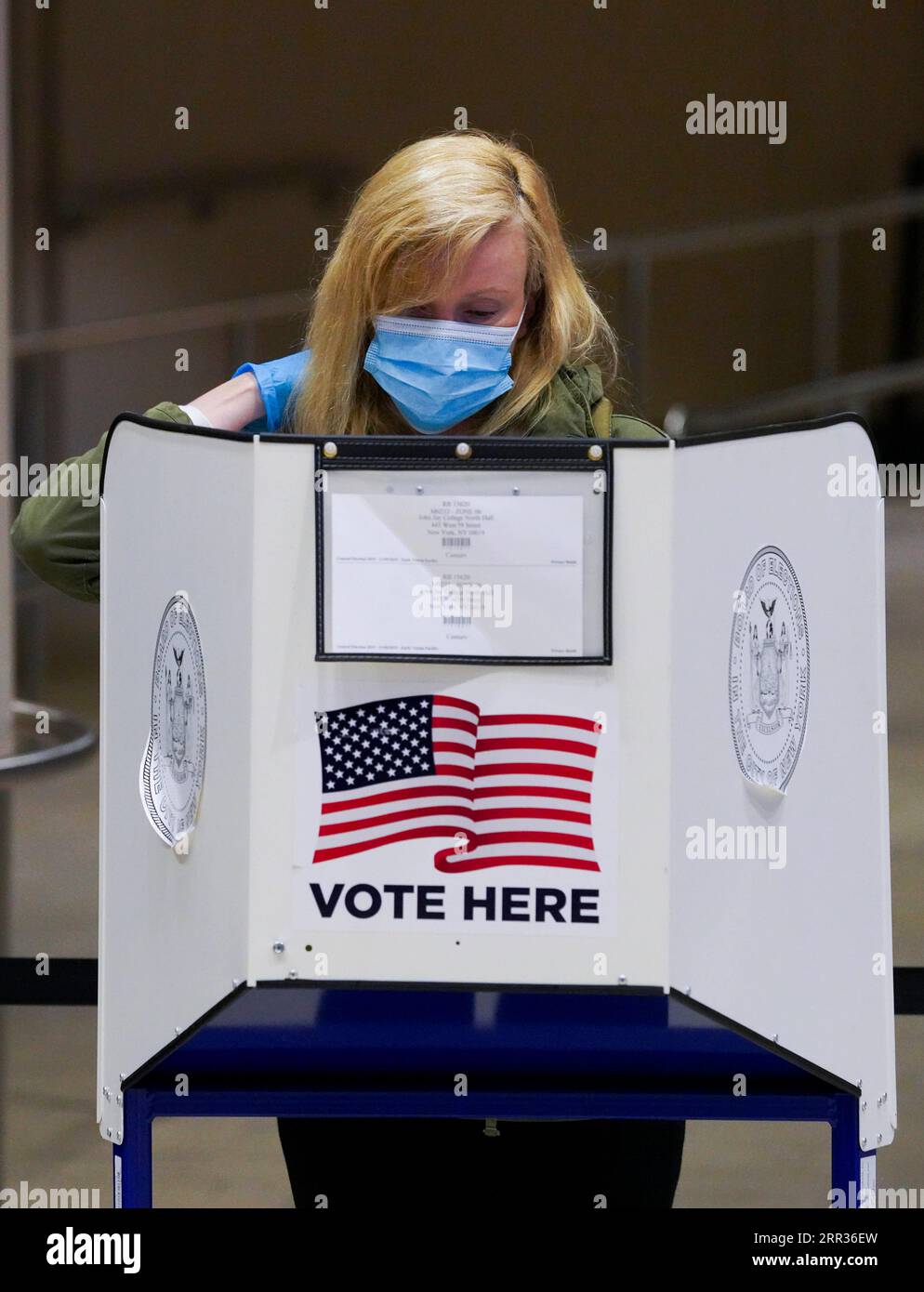 201024 -- NEW YORK, Oct. 24, 2020 -- A voter fills out her ballot ...
