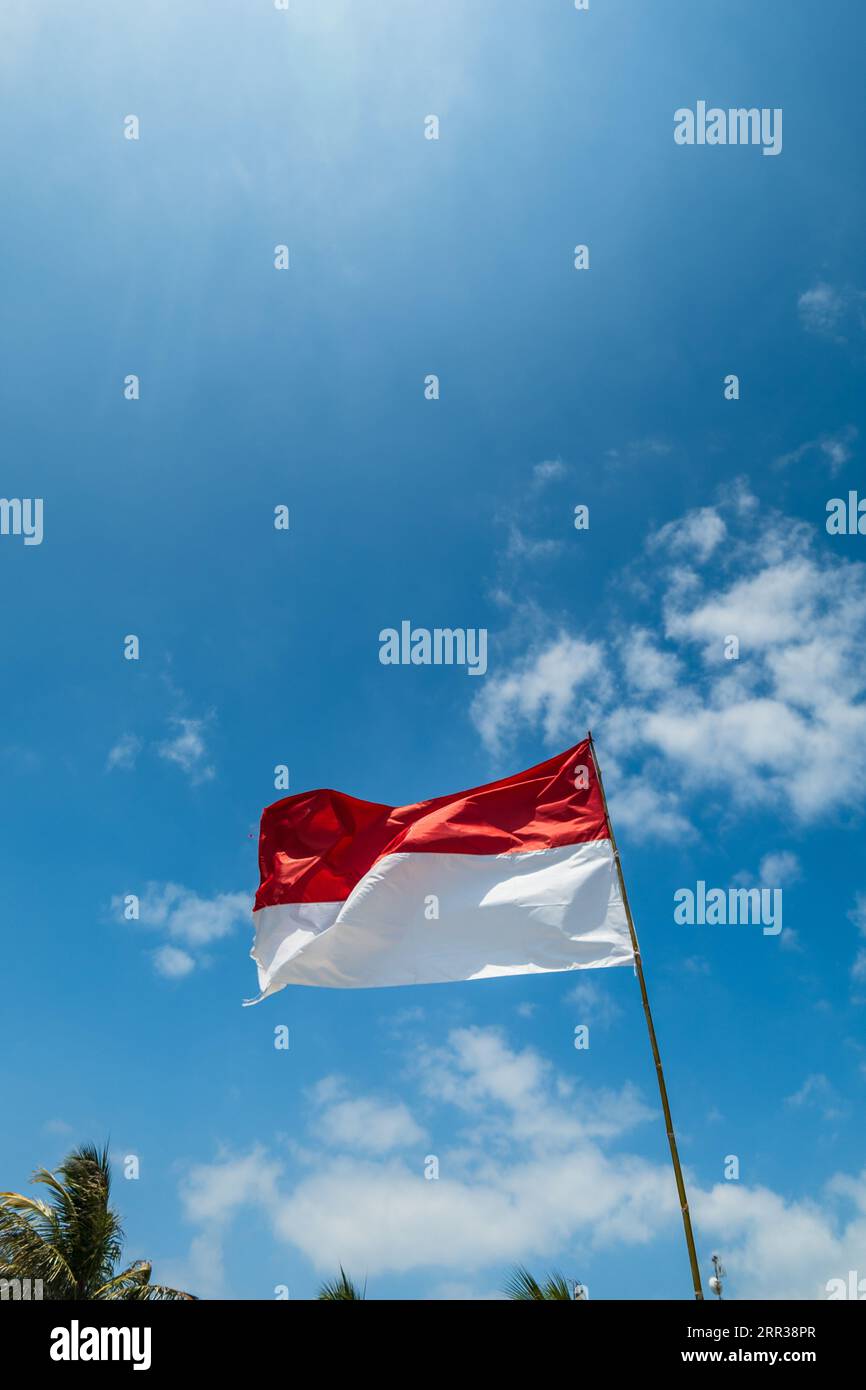Indonesia flag waving in wind on blue sky background. International ...
