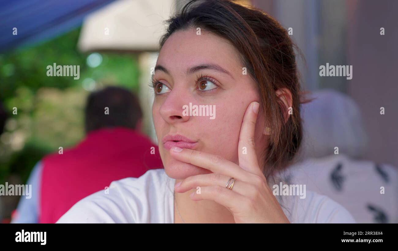 Pensive 30s woman close-up face gazing in the distance thinking while ...