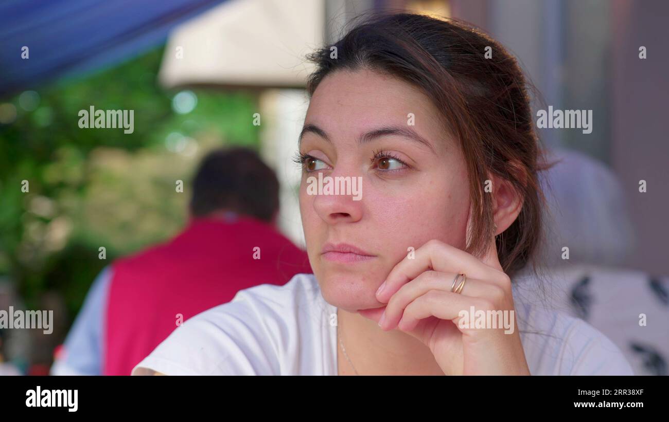 Reflective Woman in Her 30s, Deep in Thought at Restaurant, Awaiting ...