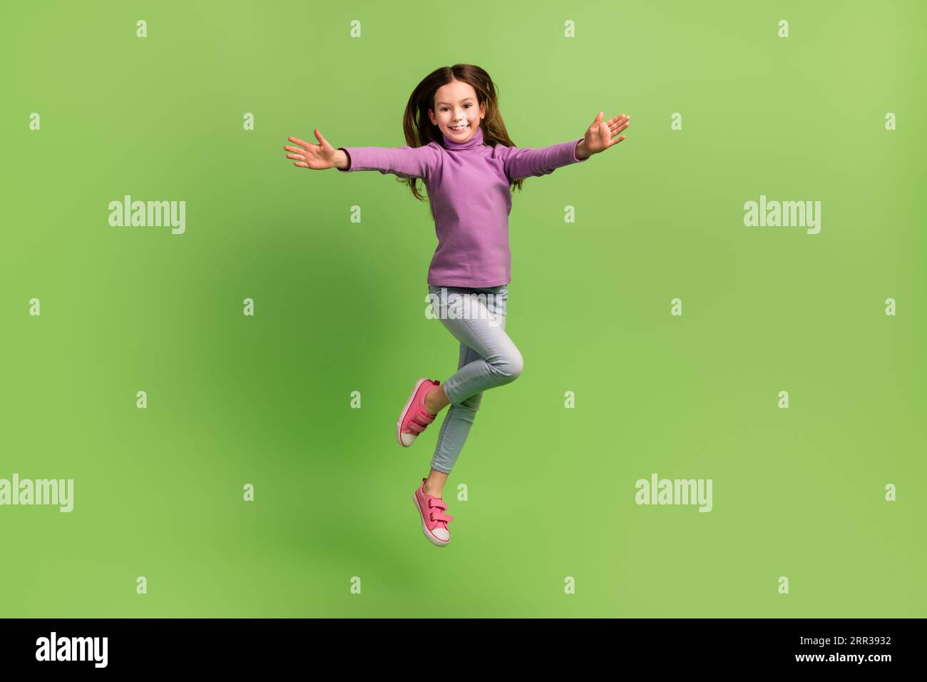 Full body cadre of funky schoolkid little girl jump active free time ...