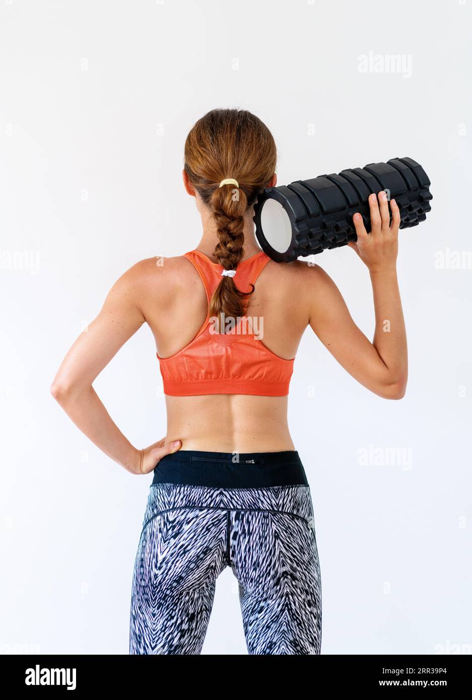 Rear view photo of female fitness coach standing in front of white ...