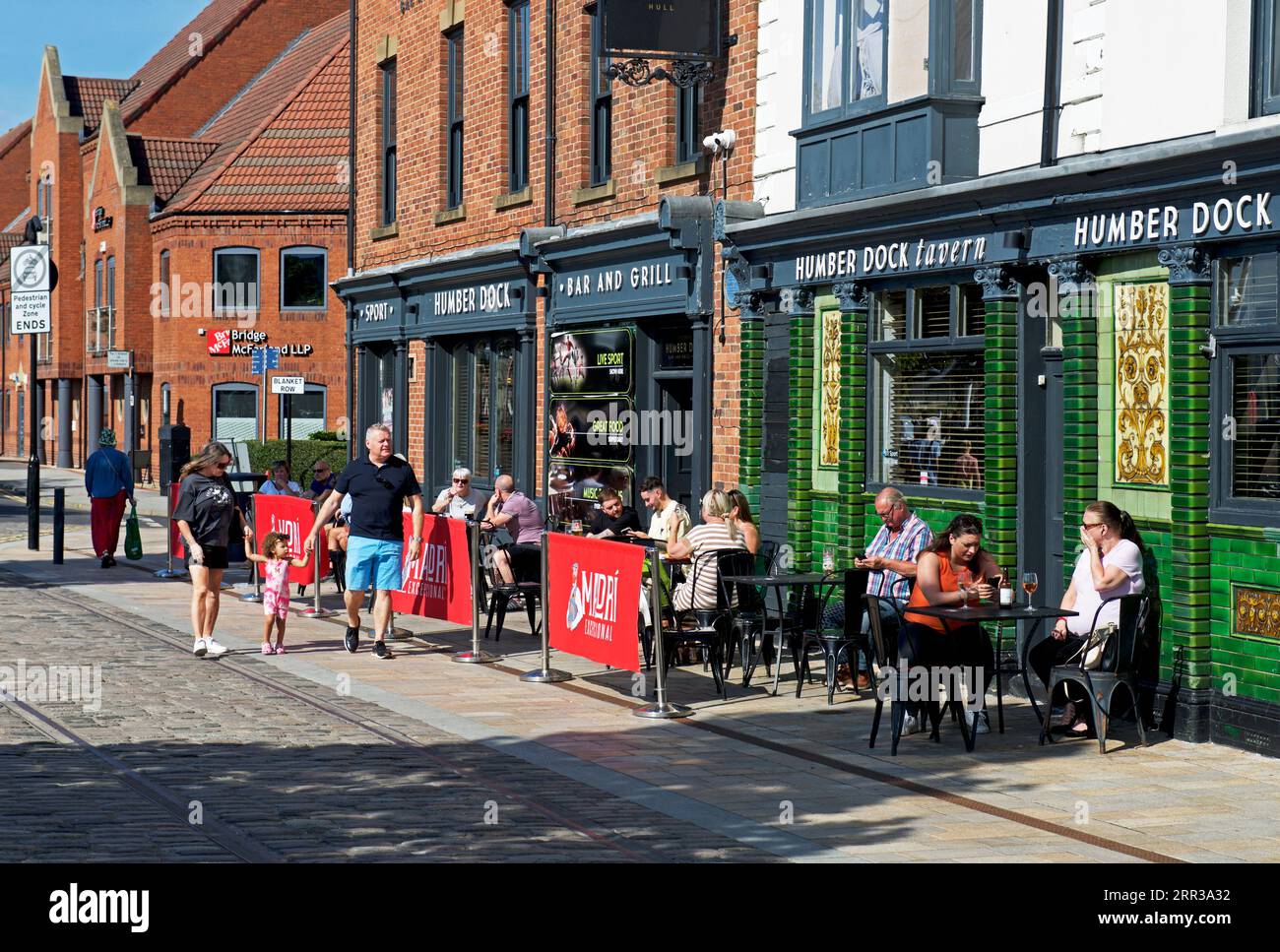 People sitting outside the Humber Dock Bar & Grill, on Humber Dock ...