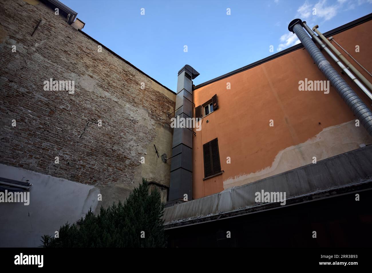 Corner of two buildings in an inner yard at sunset Stock Photo - Alamy