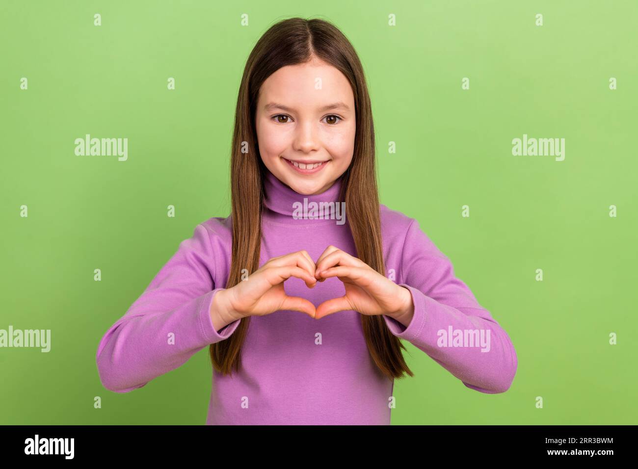 Photo of friendly cute daughter small kid showing fingers heart symbol ...
