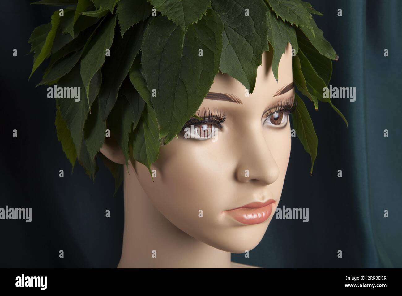 a display mannequin wearing hair of leaves and representing a nature ...