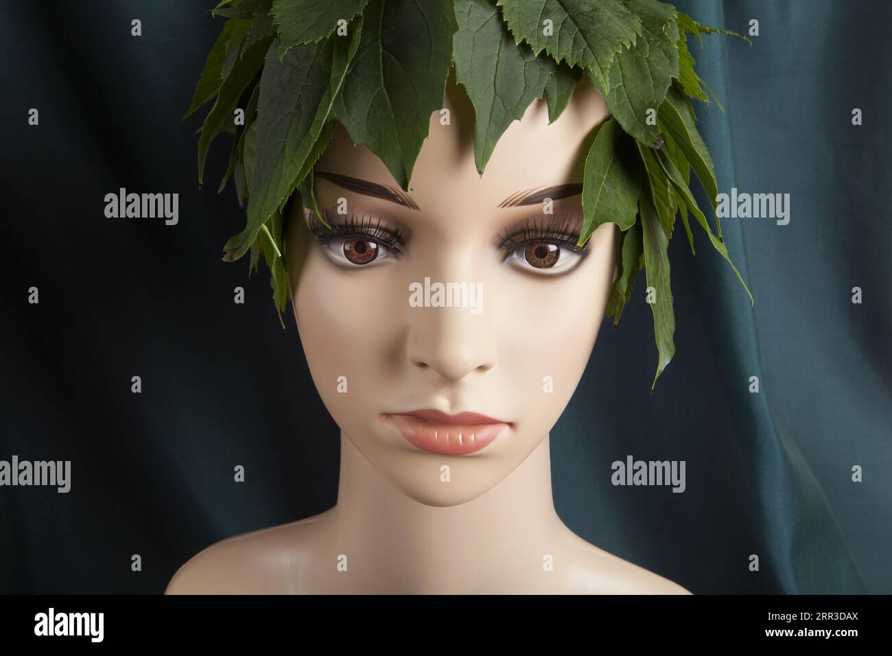 a display mannequin wearing hair of leaves and representing a nature ...