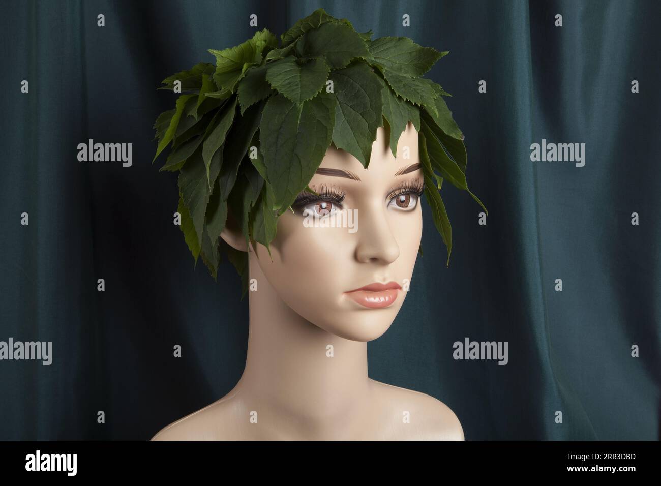 a display mannequin wearing hair of leaves and representing a nature ...