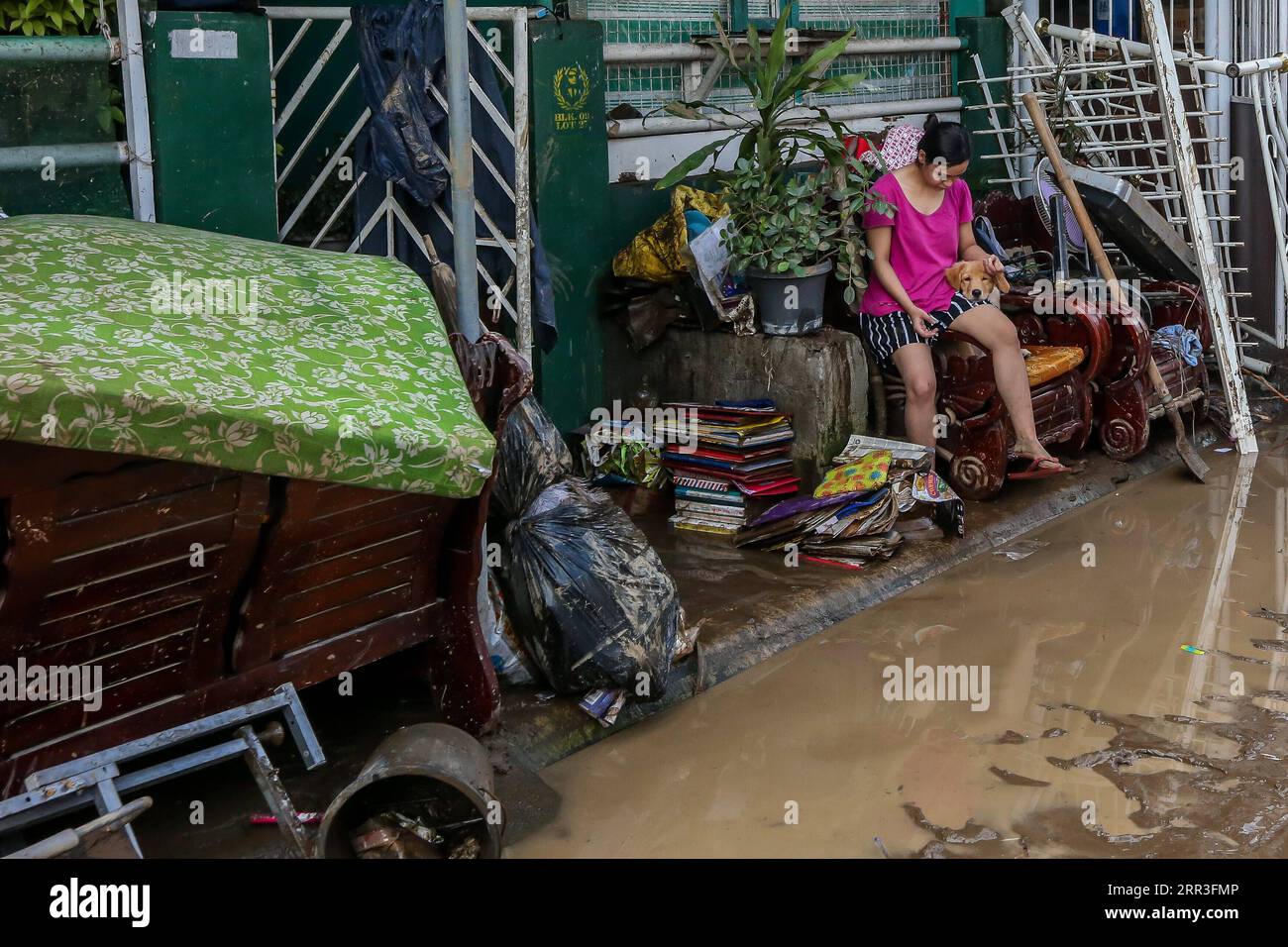 201102 -- BATANGAS PROVINCE, Nov. 2, 2020 -- A resident sits with her ...