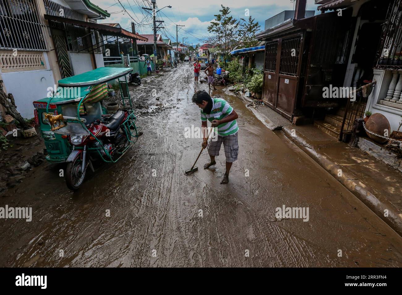 201102 -- BATANGAS PROVINCE, Nov. 2, 2020 -- A man cleans a road ...