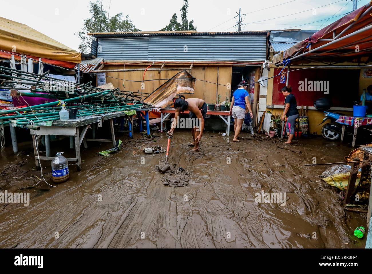 201102 -- BATANGAS PROVINCE, Nov. 2, 2020 -- Residents clear mud and ...