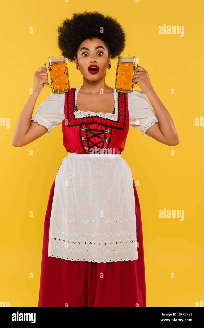 amazed african american waitress in traditional bavarian costume ...