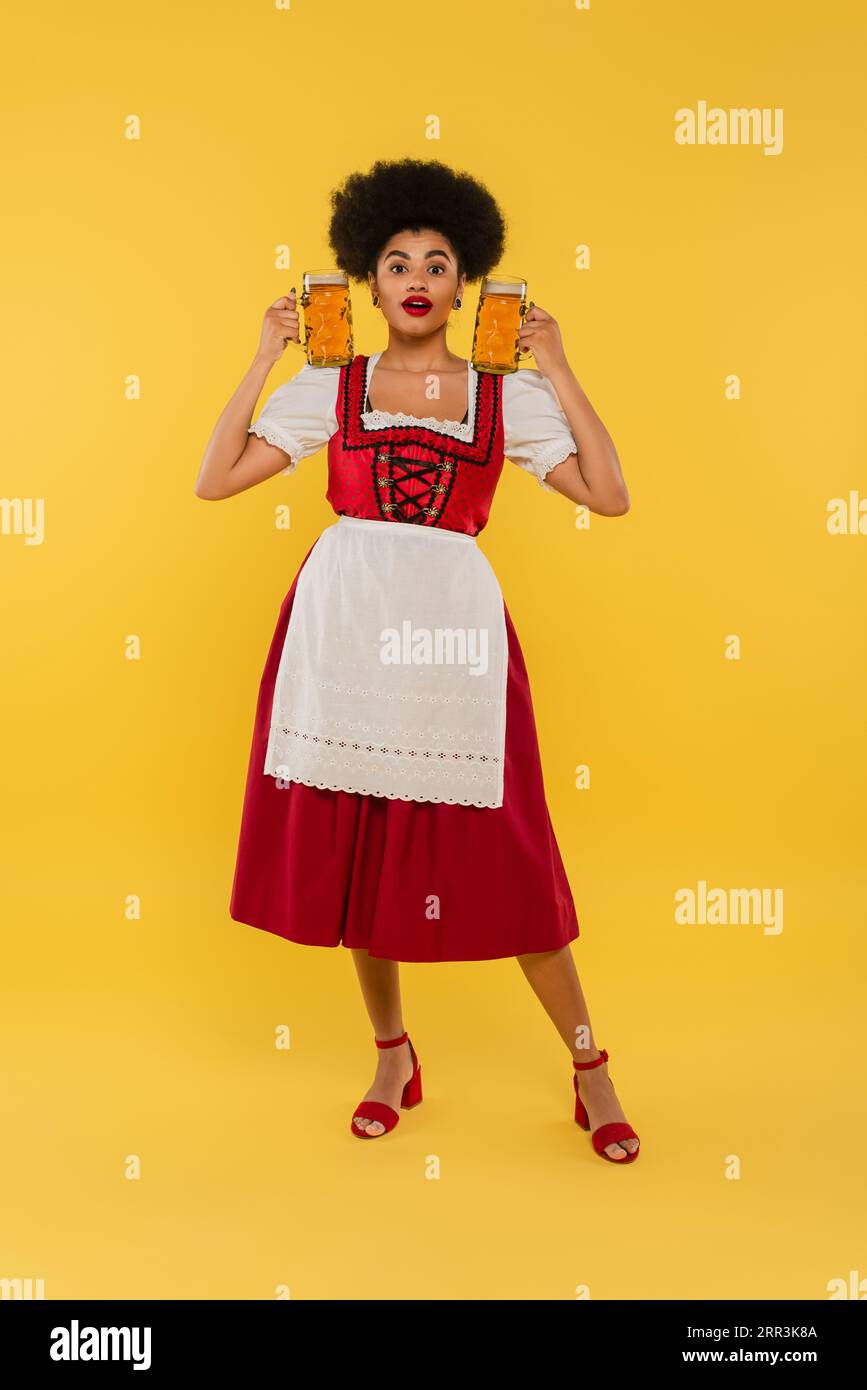 impressed african american waitress in traditional bavarian costume ...