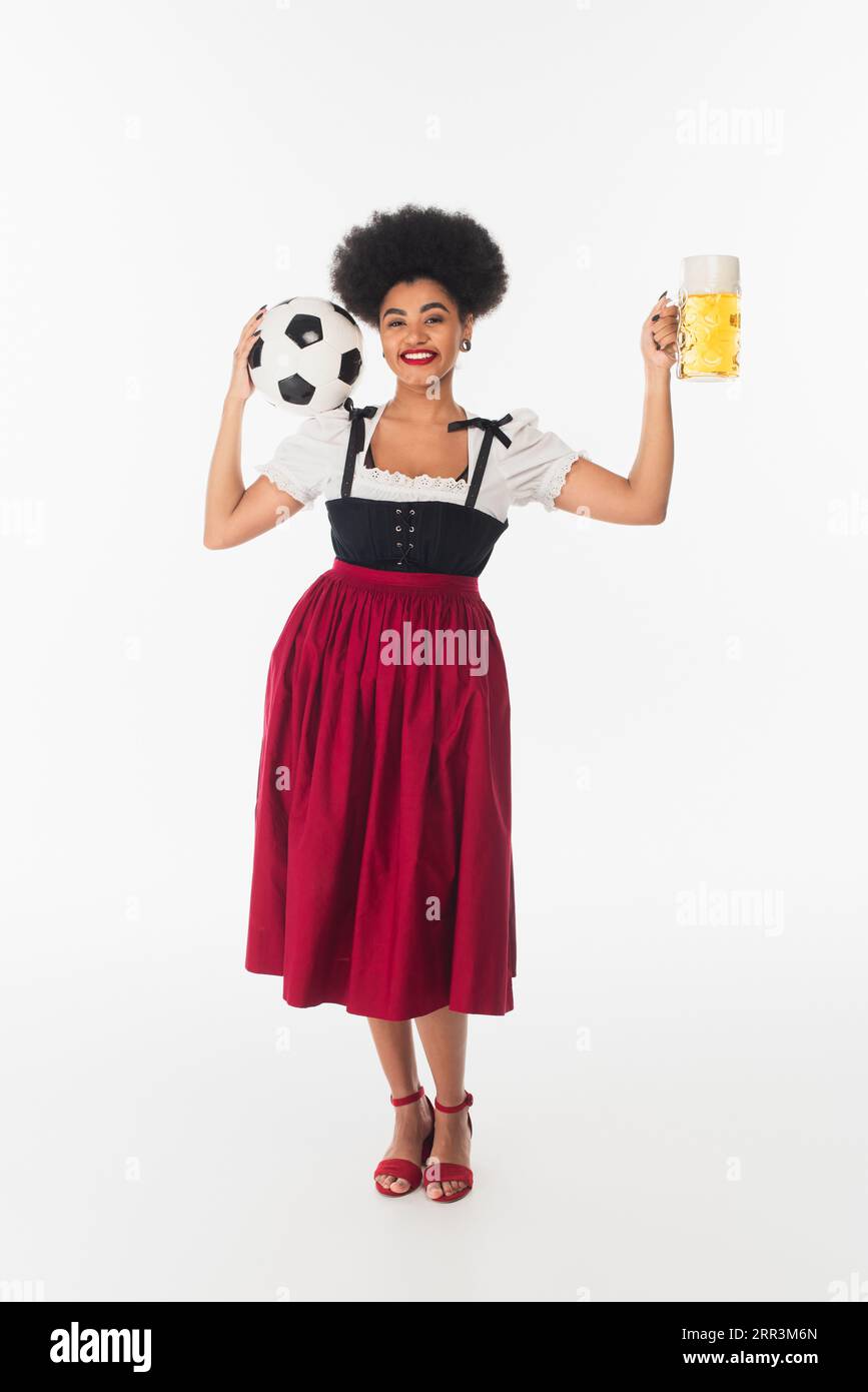 excited african american waitress in oktoberfest costume with beer mug ...