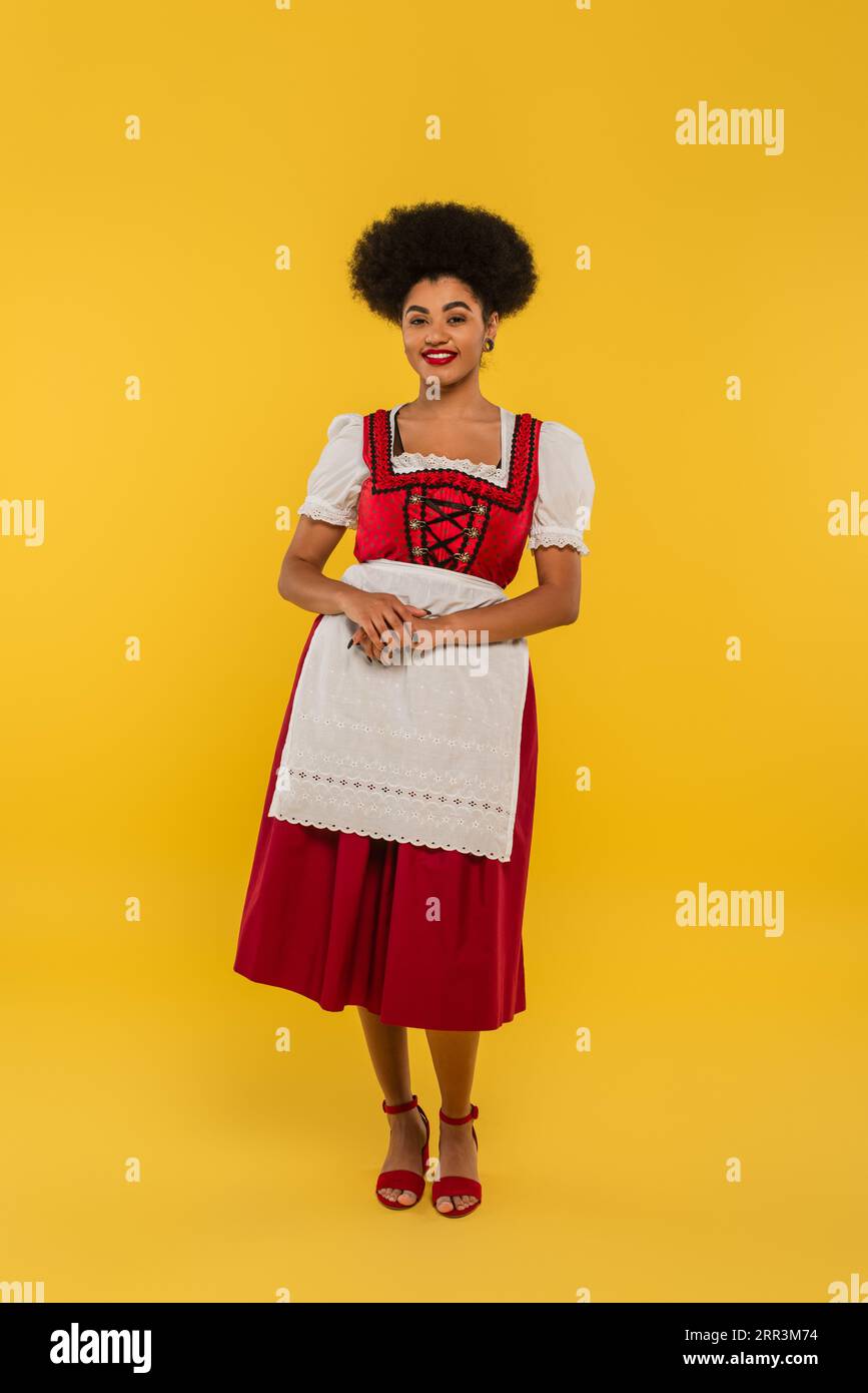 joyful african american bavarian waitress in oktoberfest costume ...