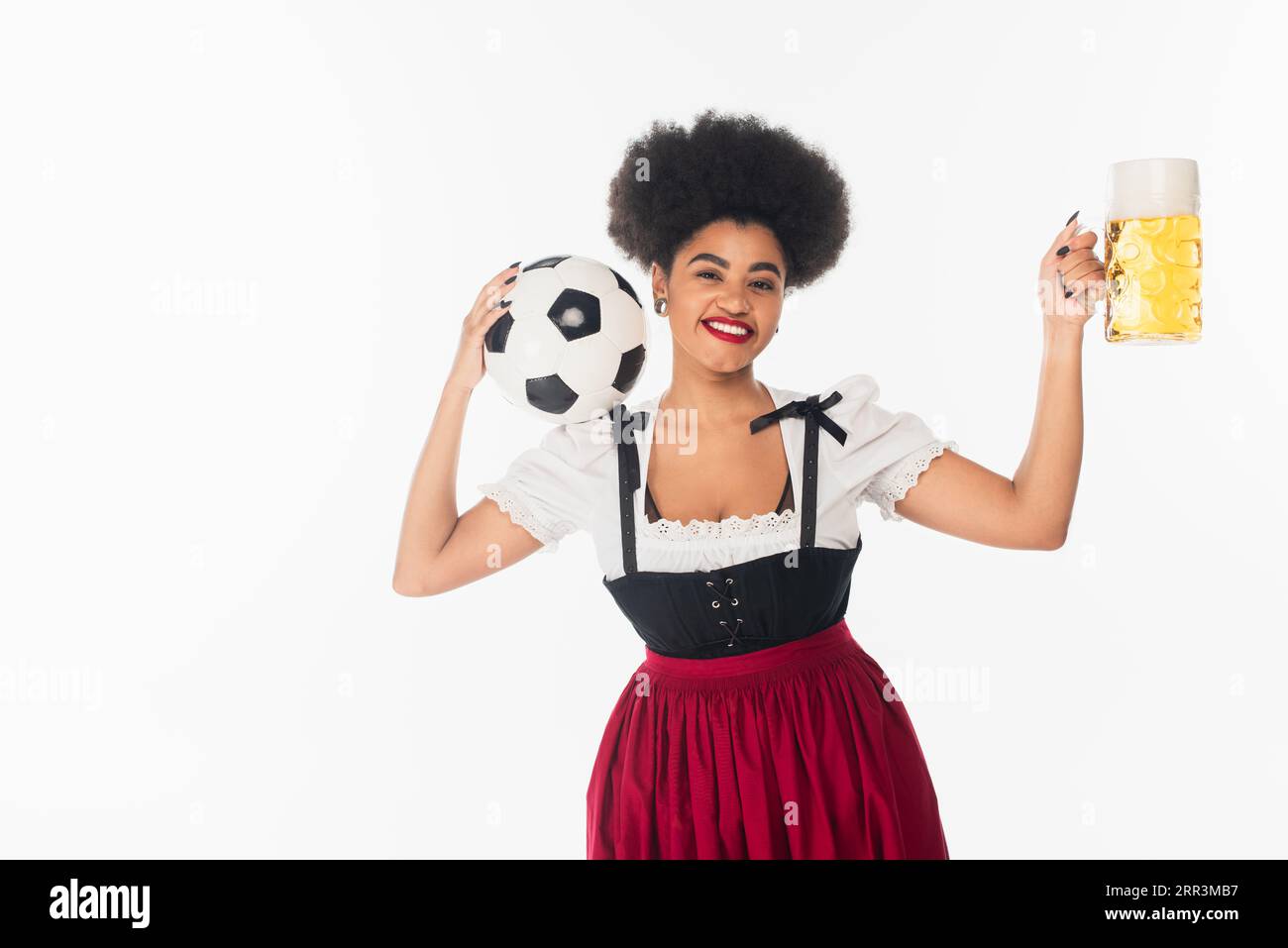 joyous african american waitress in bavarian dirndl posing with soccer ...