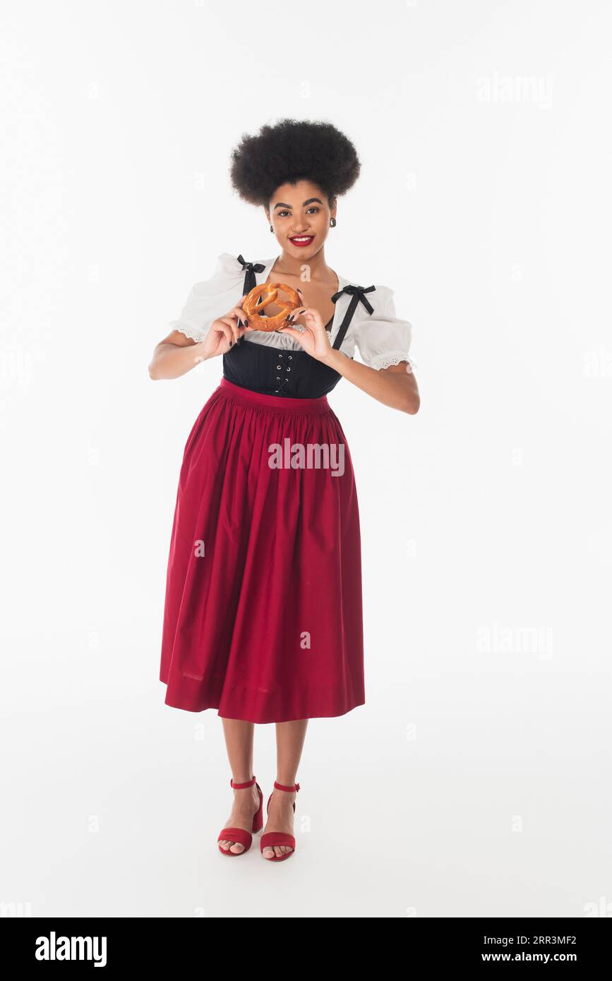 african american bavarian waitress in elegant dirndl with delicious ...