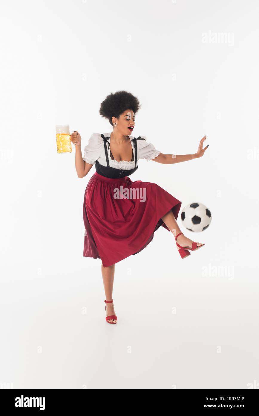 cheerful african american bavarian waitress with mug of foamy bear ...