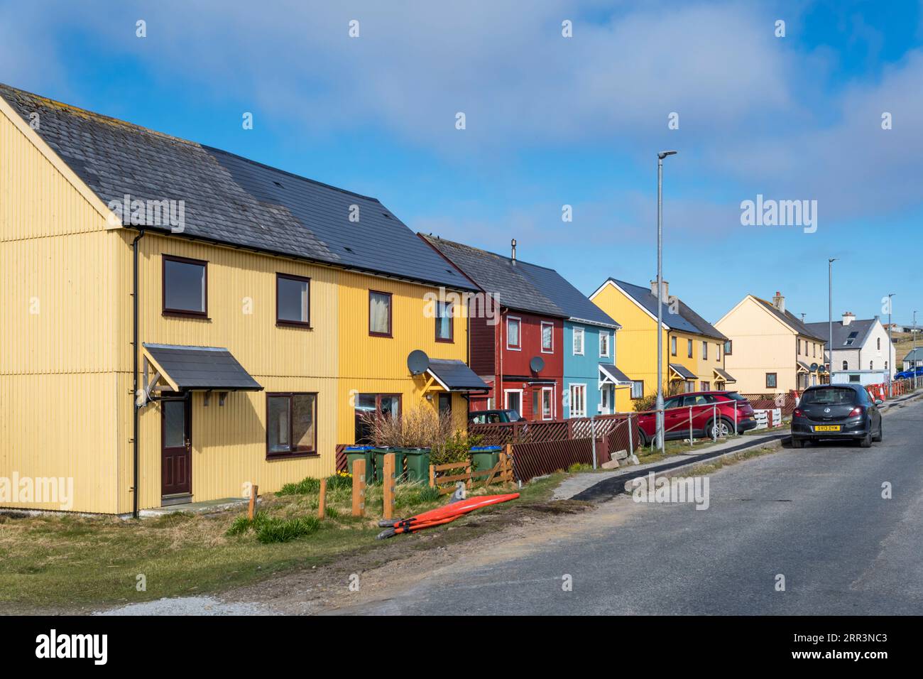 Bright coloured cladding on houses at Burravoe in the south of the ...