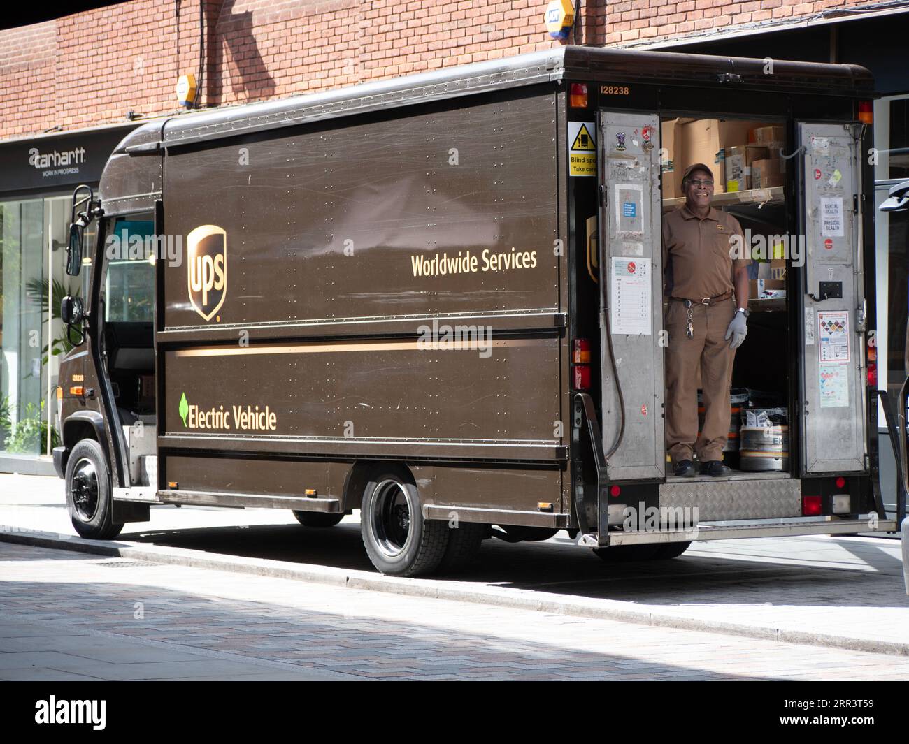 UPS parcel worker with electric van in Seven Dials London Stock Photo ...