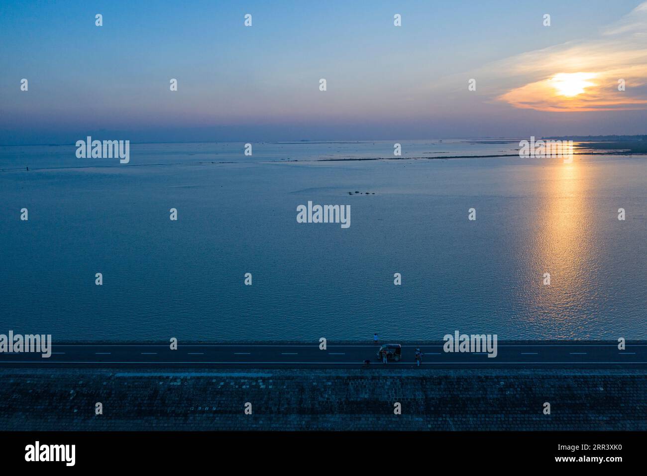 Itna-Mithamoin-Austagram all-weather road goes straight through a vast haor area in parallel ...