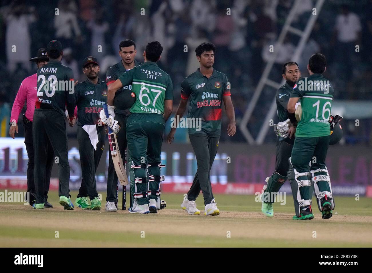 Pakistan's Mohammad Rizwan, right, and Agha Salman, center, shake hands with Bangladeshi players ...