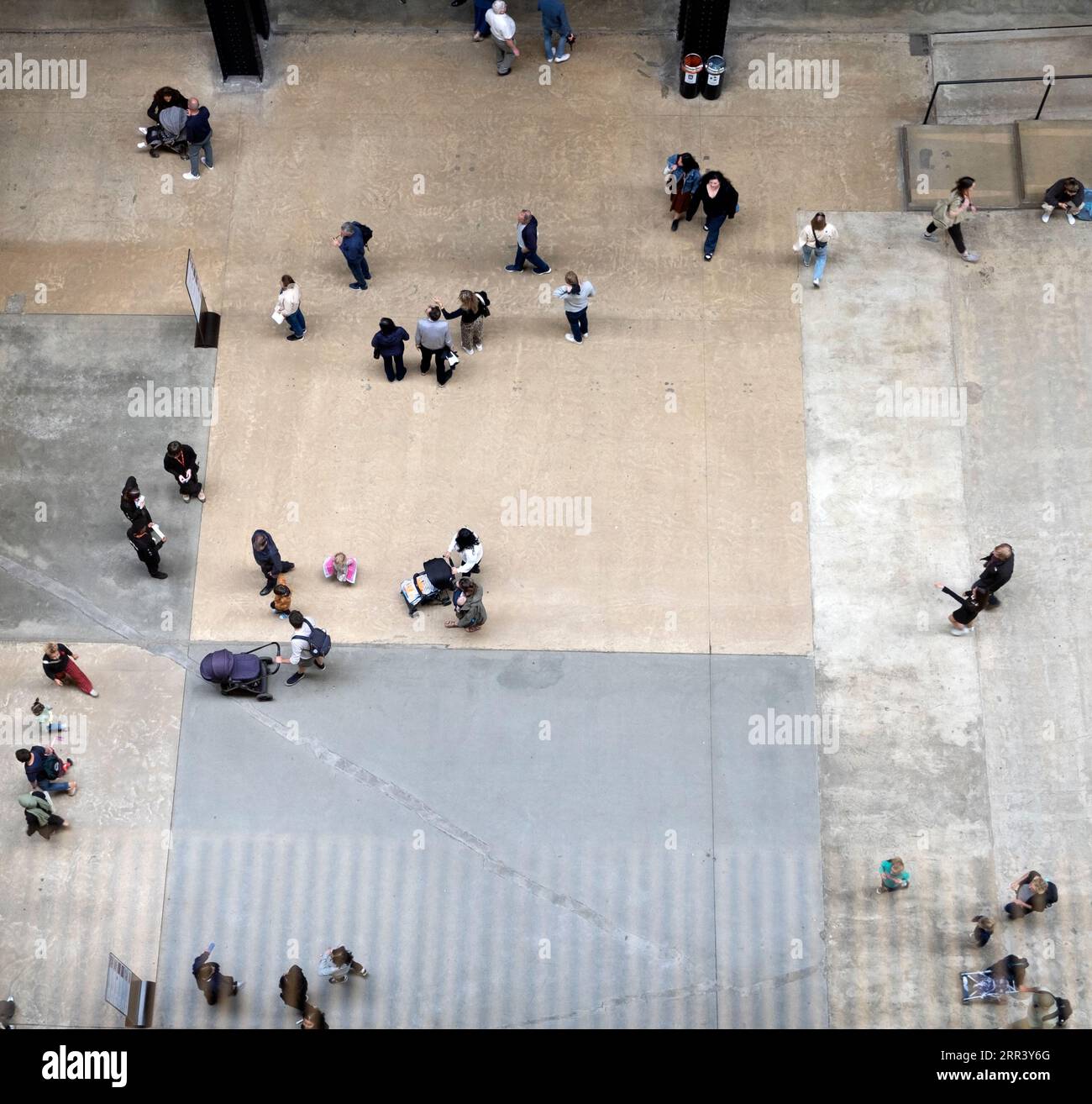 View looking down from above of people visitors walking on the floor of the Tate Modern Art ...