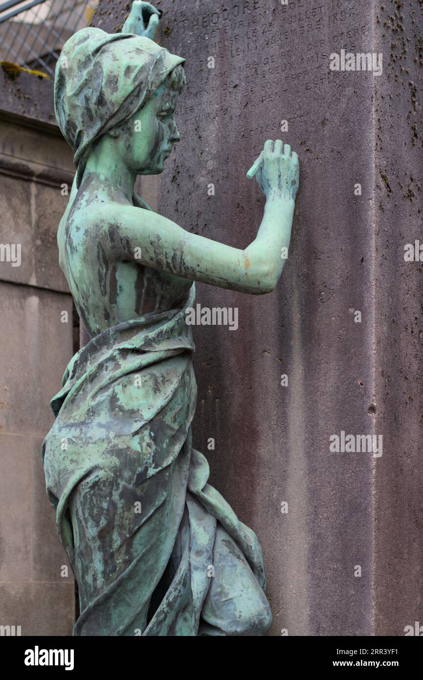 Bronze statue of a woman writing a tribute to Keller on the stele ...