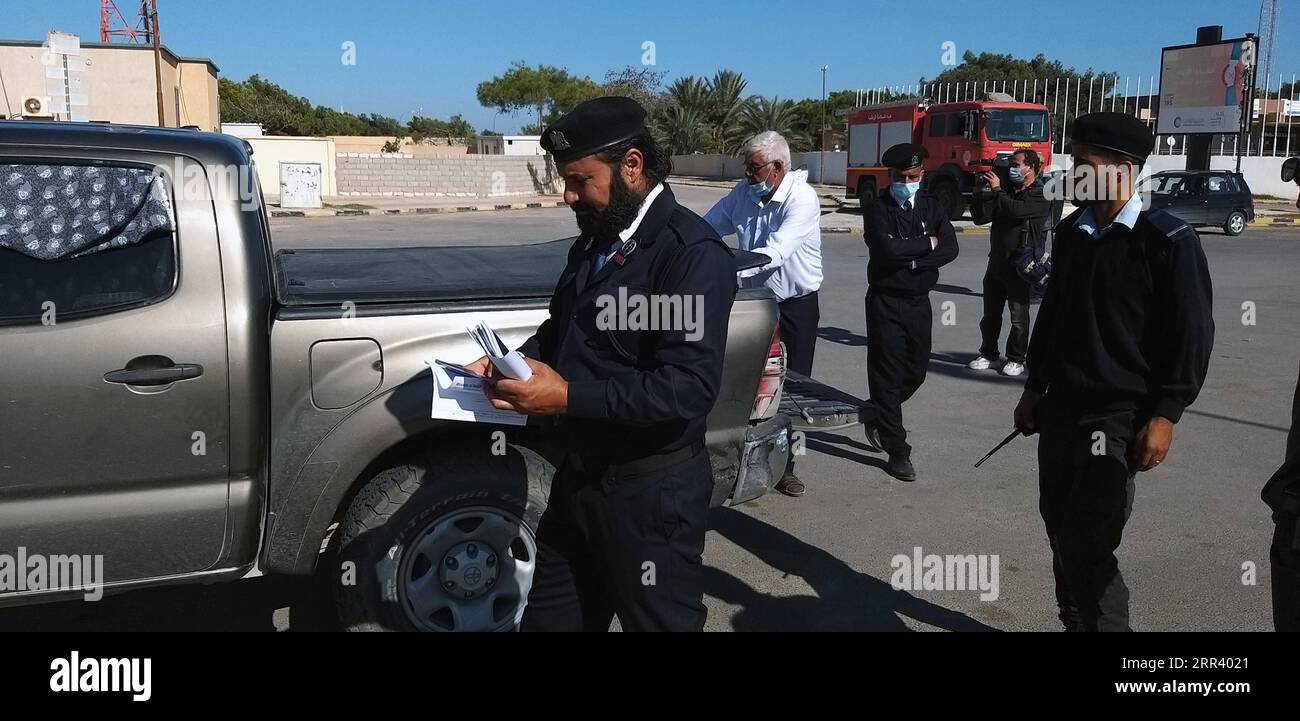 201114 -- RAS EJDER BORDER, Nov. 14, 2020 -- Libyan security workers ...