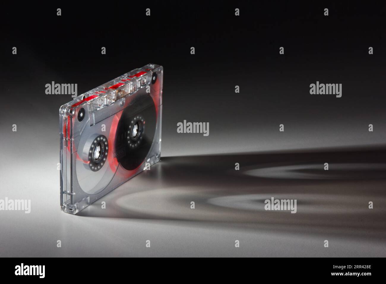 vintage analog audio cassette with transparent case and visible tape ...