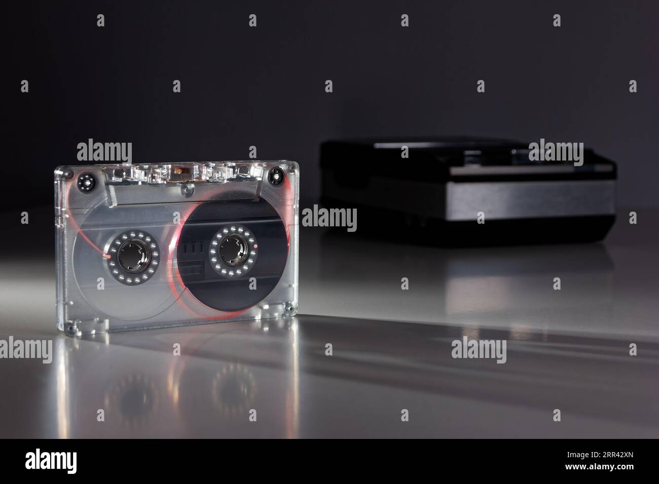 vintage analog audio cassette with transparent case and visible tape ...