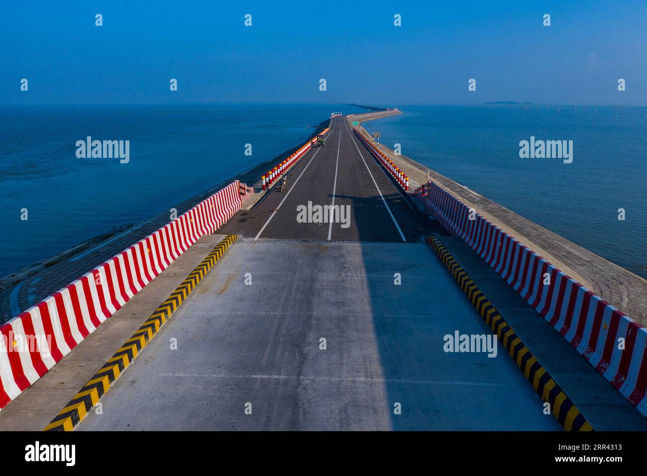 Itna-Mithamoin-Austagram all-weather road goes straight through a vast haor area in parallel ...