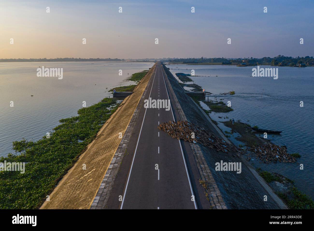 Itna-Mithamoin-Austagram all-weather road goes straight through a vast haor area in parallel ...