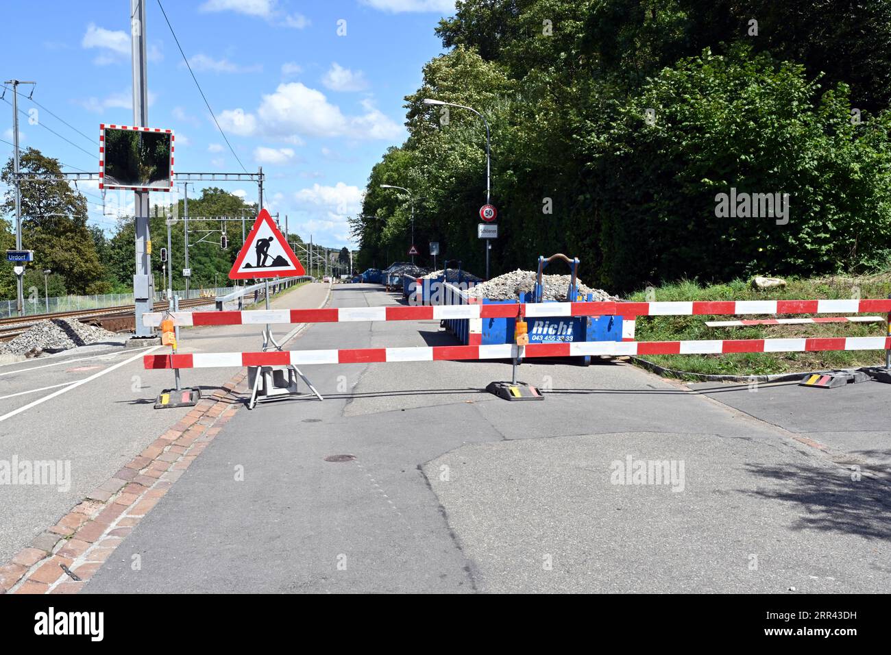 Triangle traffic sign Men at work placed on a red and white wooden ...