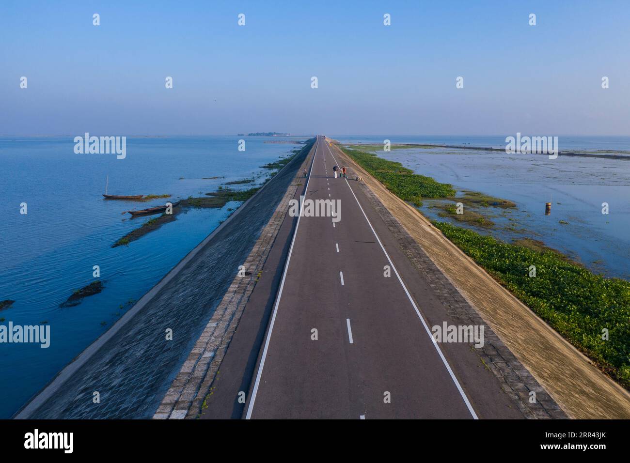 Itna-Mithamoin-Austagram all-weather road goes straight through a vast haor area in parallel ...