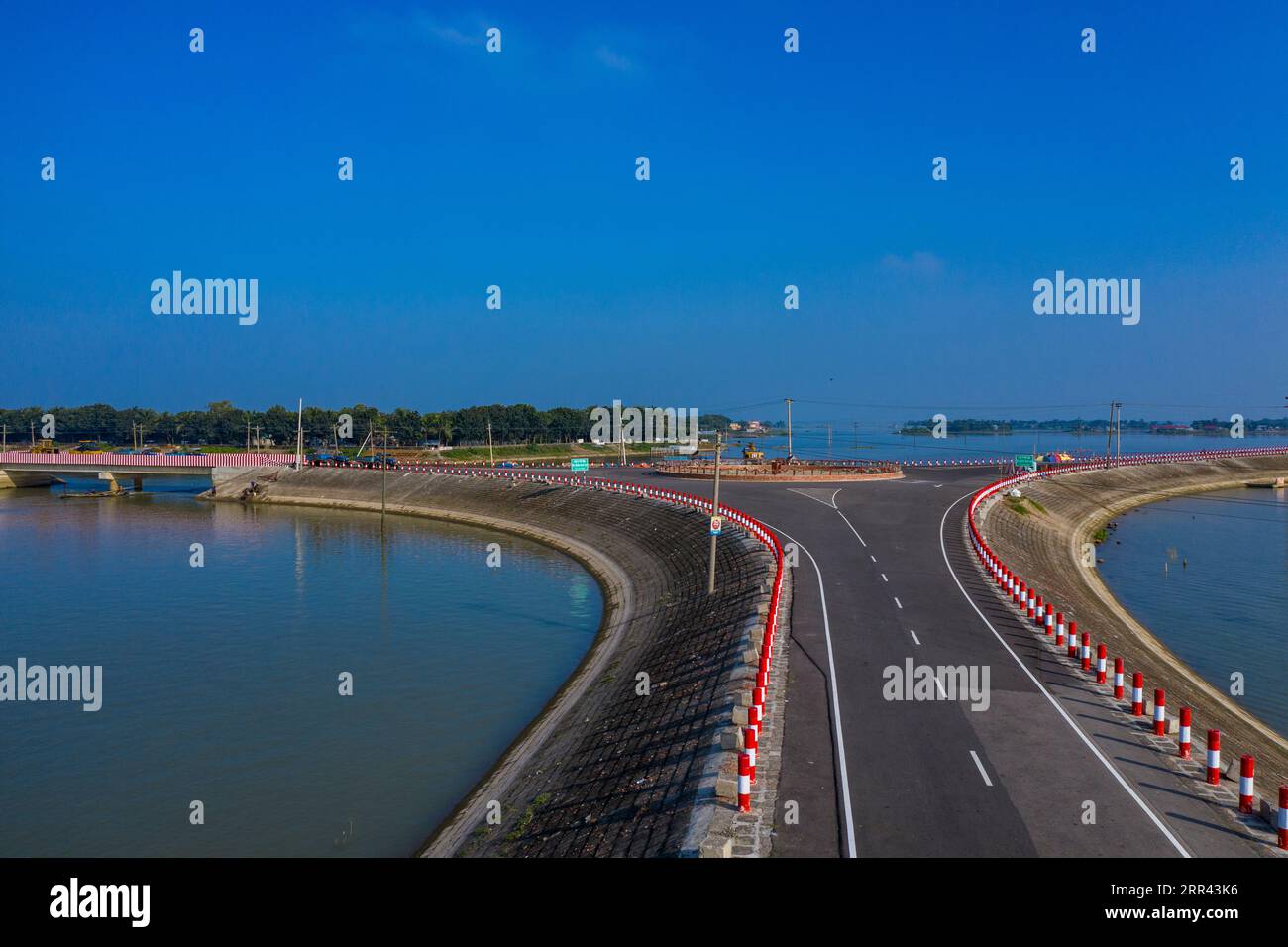 Itna-Mithamoin-Austagram all-weather road goes straight through a vast haor area in parallel ...