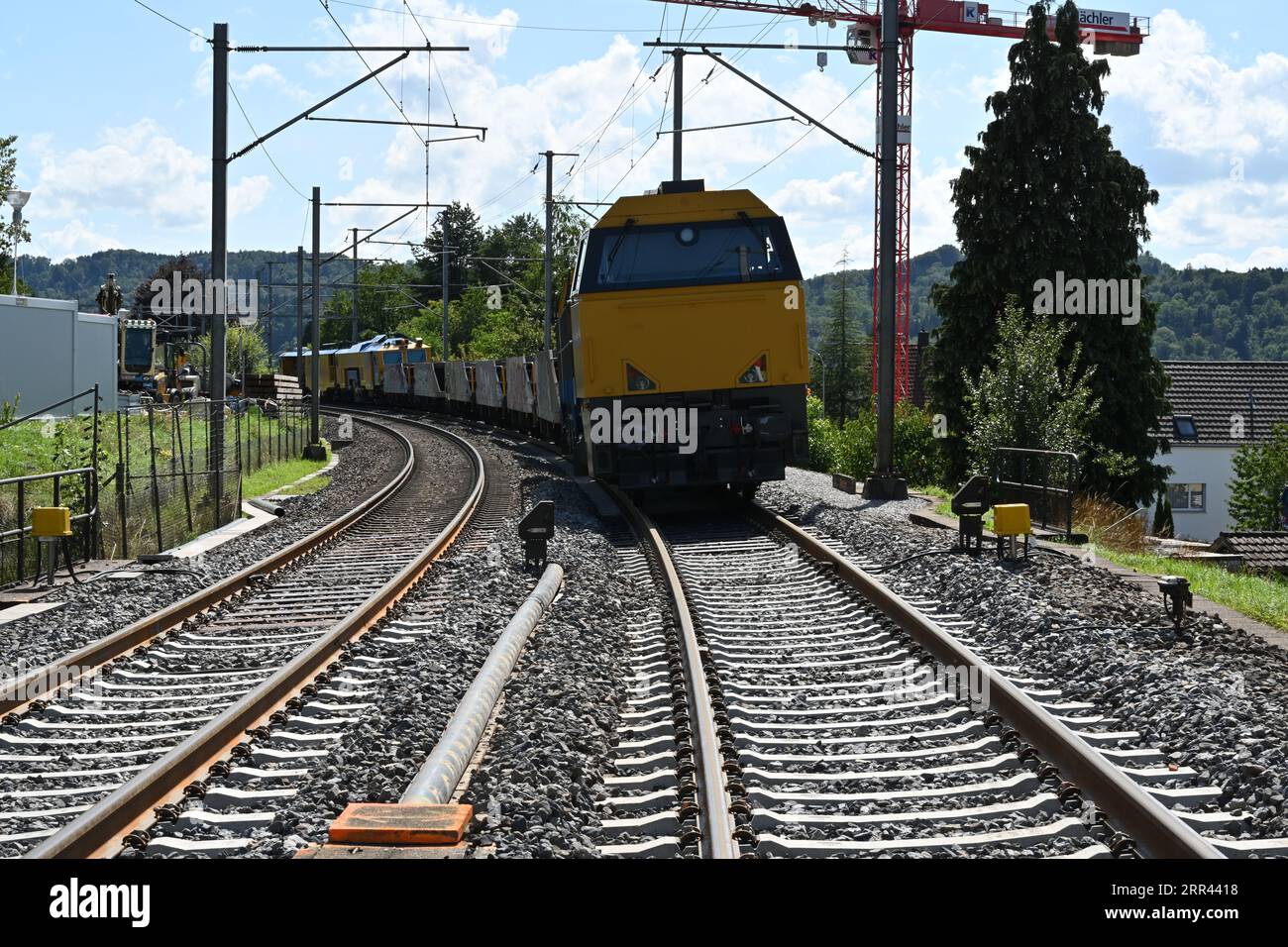 A freight train with railway carriages viewed from forward stands on ...