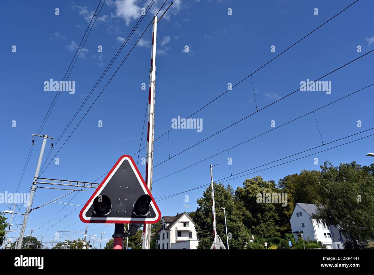 A railway level crossing with traffic lights and raised ramps located ...
