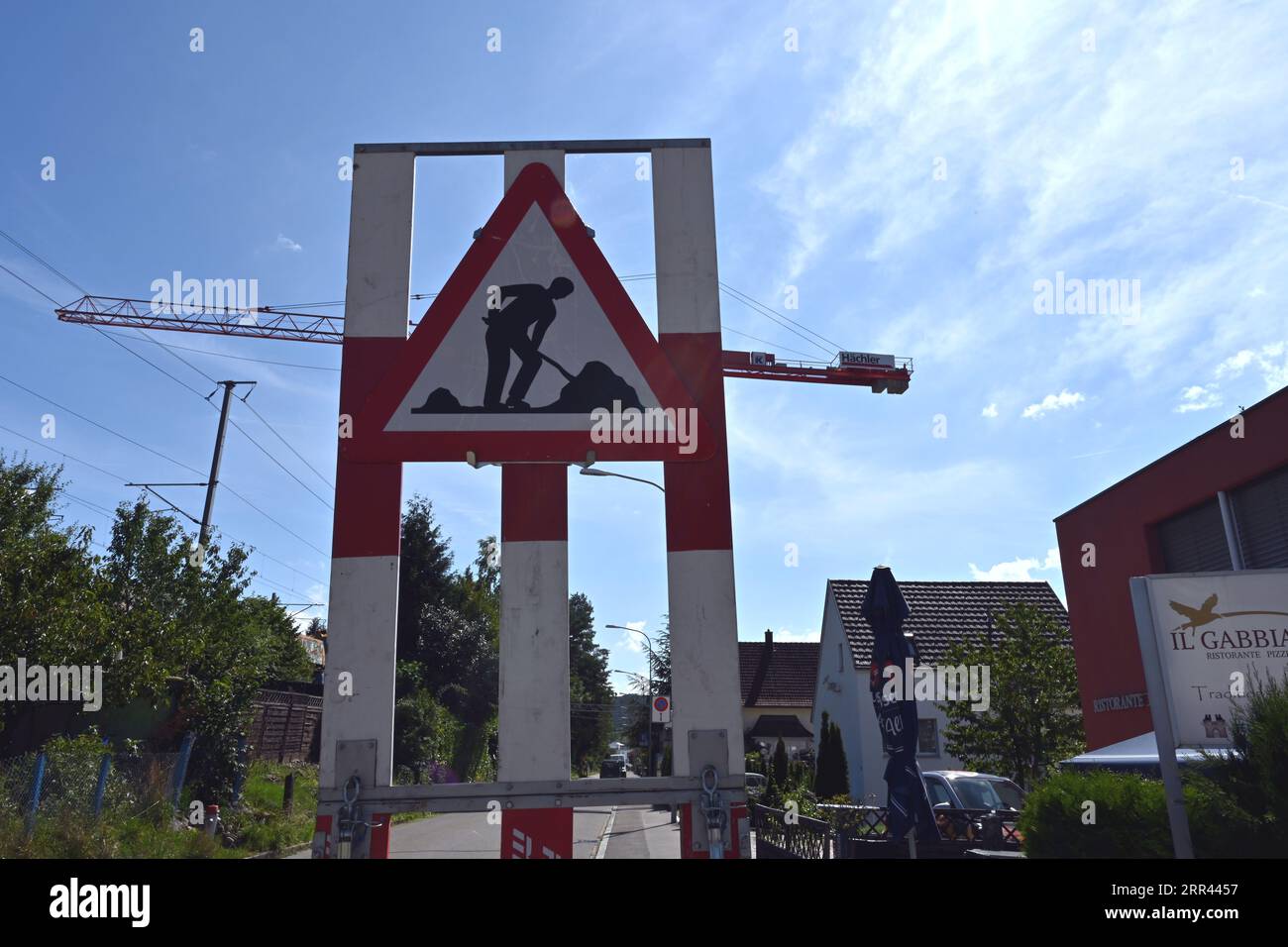 Triangle traffic sign Men at work placed on a red and white wooden ...
